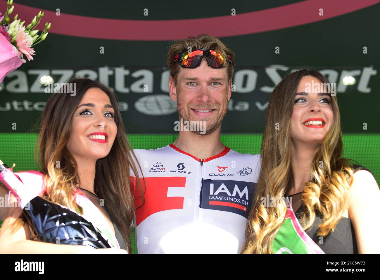 Roger Kluge (IAM Cycling) celebrates winning the stage on the podium ...