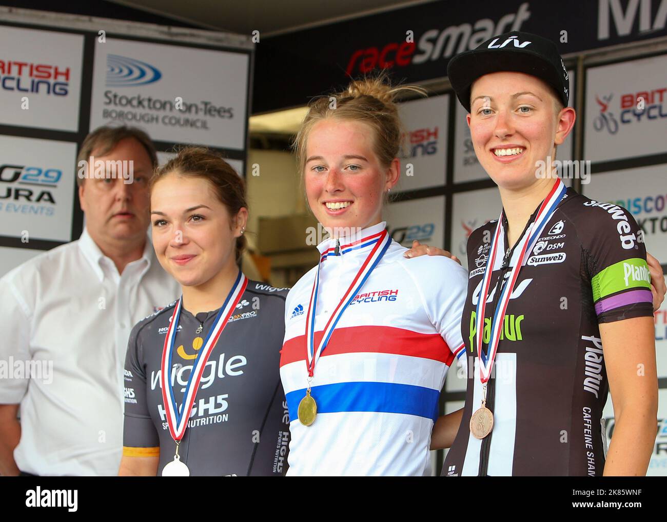 Hannah Barnes (centre) celebrates after winning the Women's road race ...
