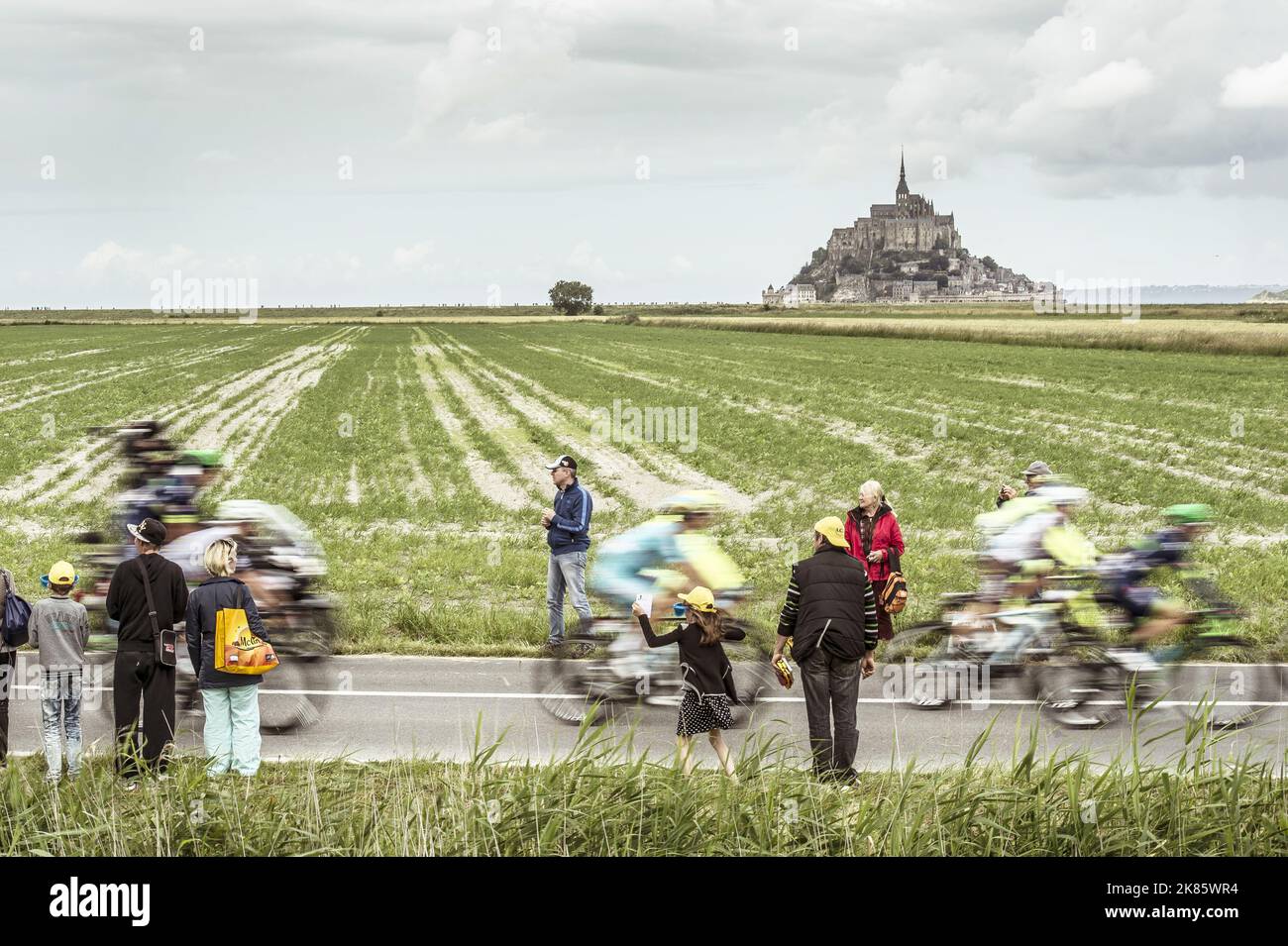 Spectators cheer as the riders roll out for the first day of racing ...
