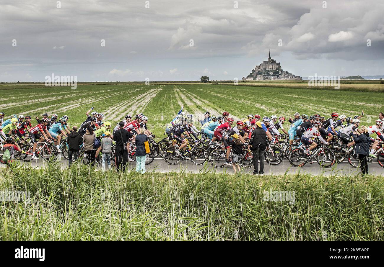 The peleton lead by the course director's car roll out on the first day ...