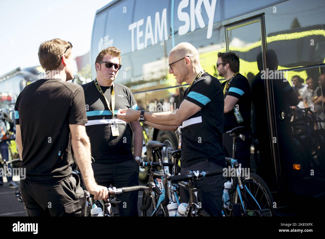 Outside the team bus the Sky team Principal Sir David Brailsford (right ...