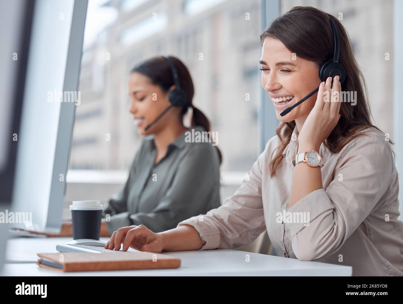 Yes its been a beautiful day. two young female call center workers in ...