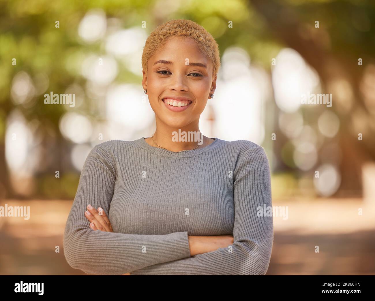 Nature, park and portrait of woman with arms crossed, happy and smile ...