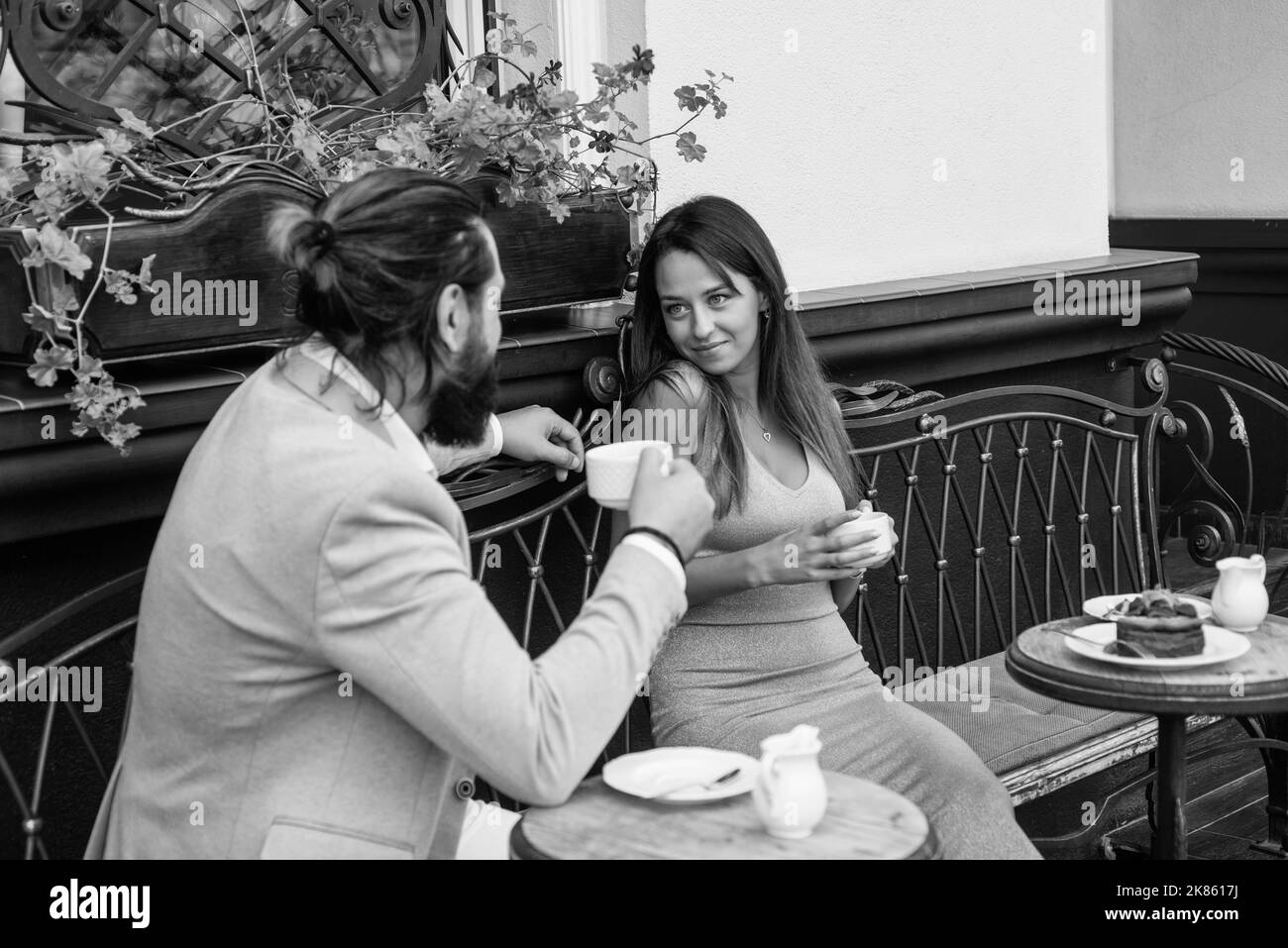 couple in love of man and woman meet in cafe outdoor drink coffee ...