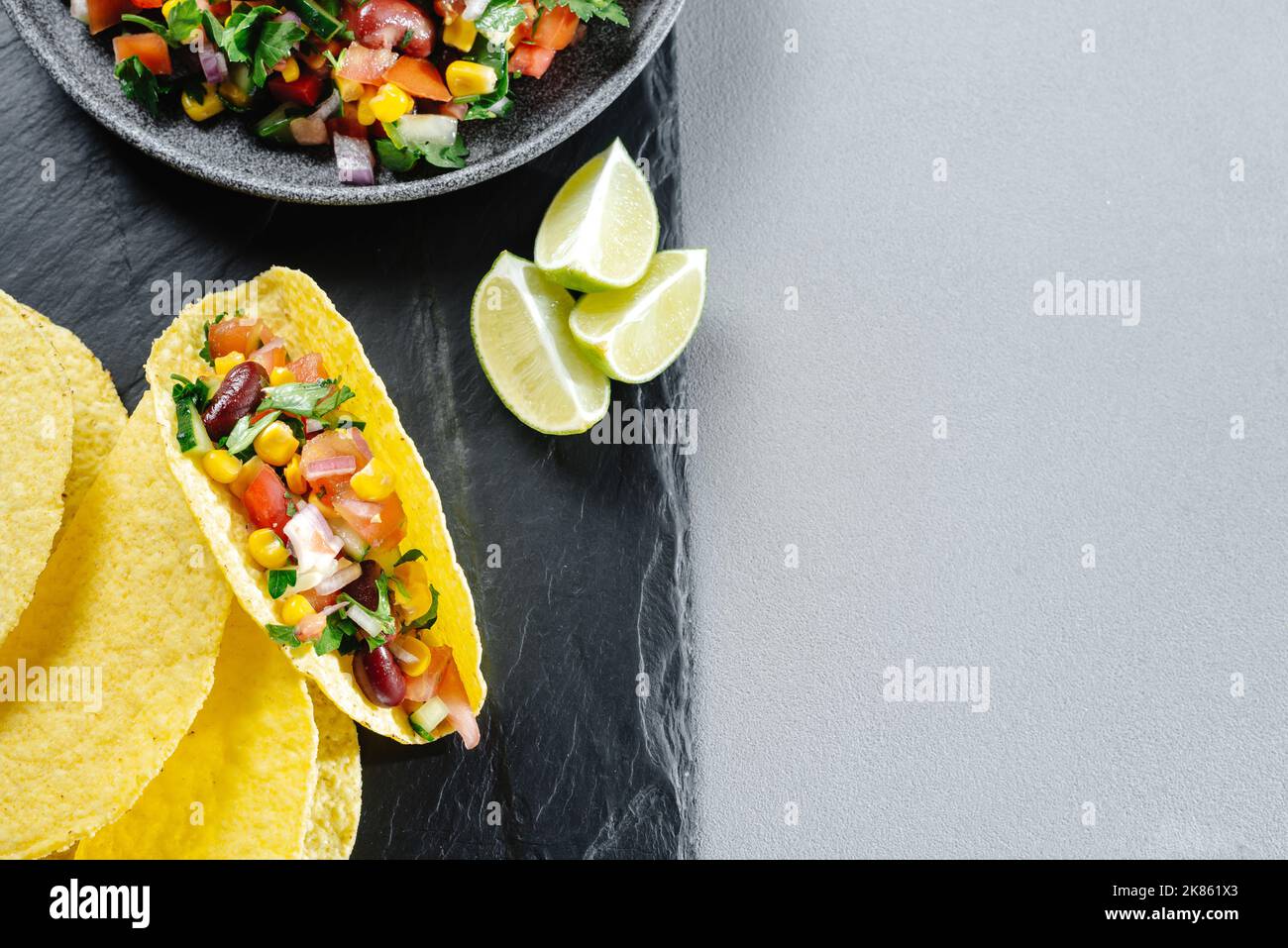 Homemade vegan tacos with black beans, corn and vegetables. The concept ...