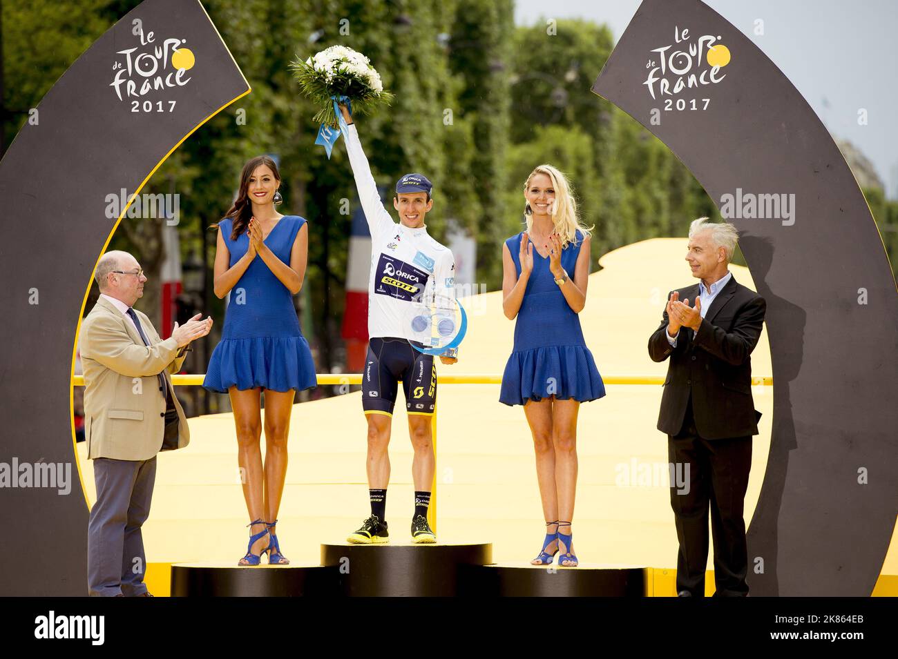 Simon Yates of team Orica Scott stands on the podium on the Champs ...