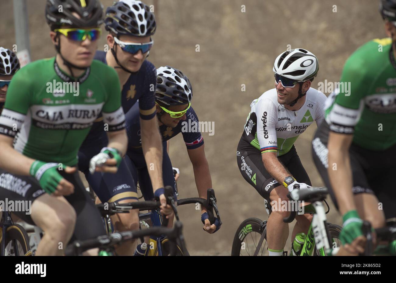 Great Britain's Mark Cavendish and Adam Blythe chat amongst the peleton ...