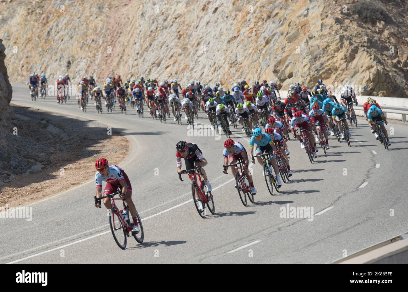 The peleton descending the Climb of Quiriyat Stage 3 Tour of Oman 2018 ...