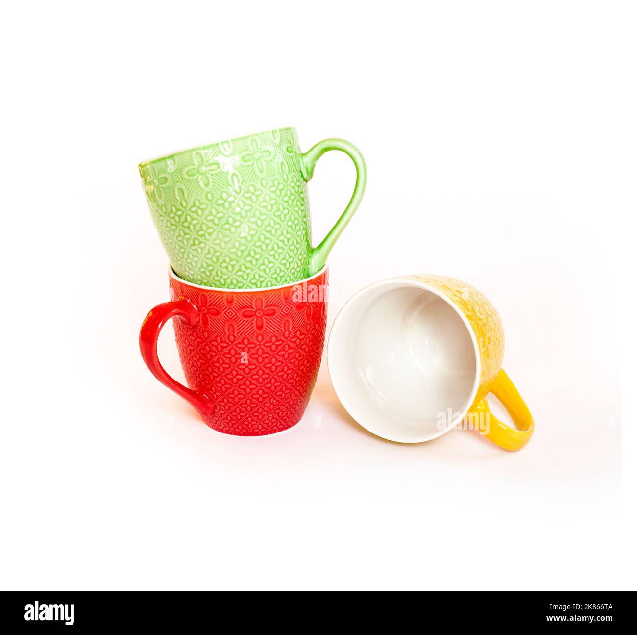 Three colorful mugs isolated on white background Stock Photo - Alamy