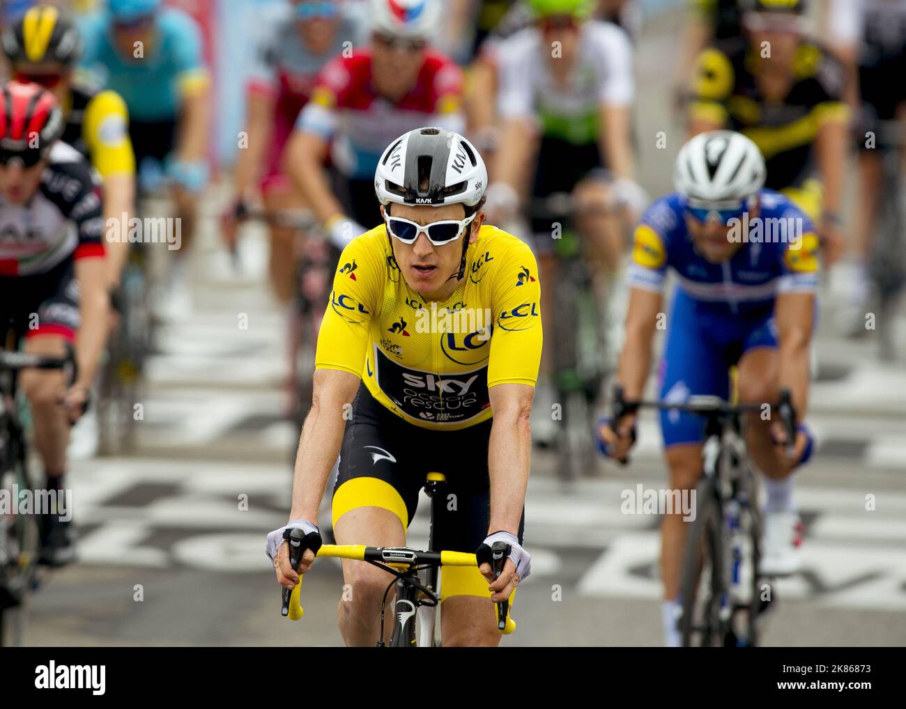 Great Britain's Geraint Thomas crosses the finish line and retains his ...