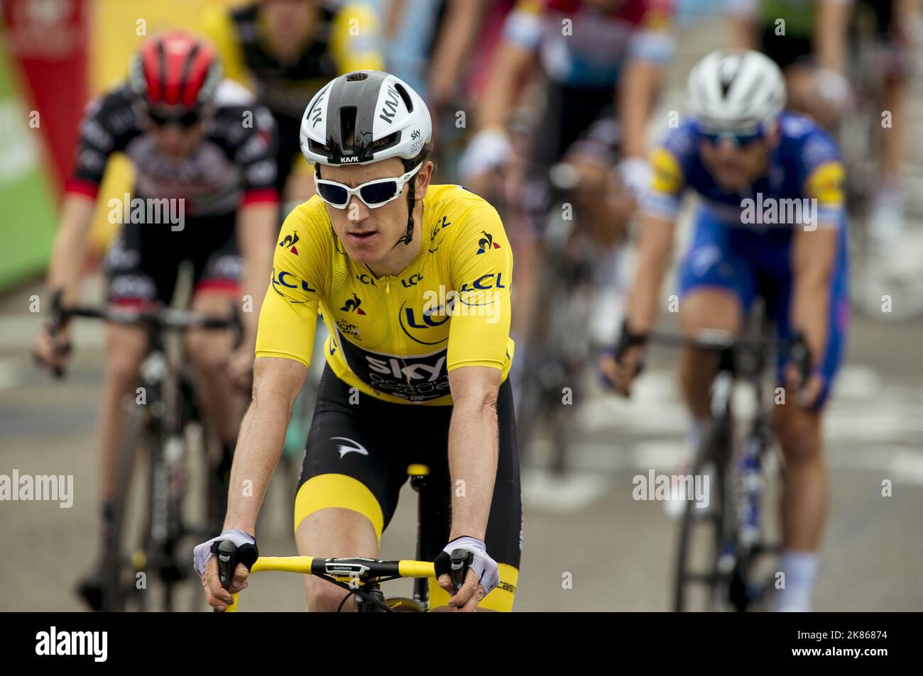 Great Britain's Geraint Thomas crosses the finish line and retains his ...