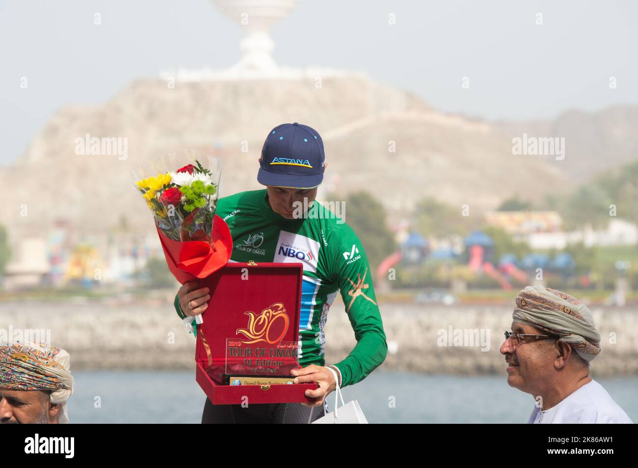 Overall winner Alexey Lutsenko stands on the podium to collect the ...