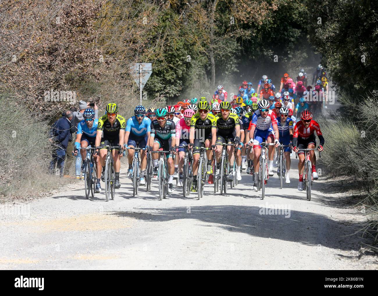 The peloton rides on an early sector of gravel before the racing ...