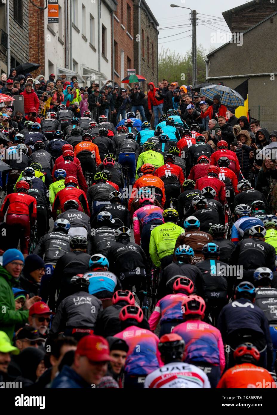 Riders climbing the wet and steep incline of La Cote du Saint Roch ...