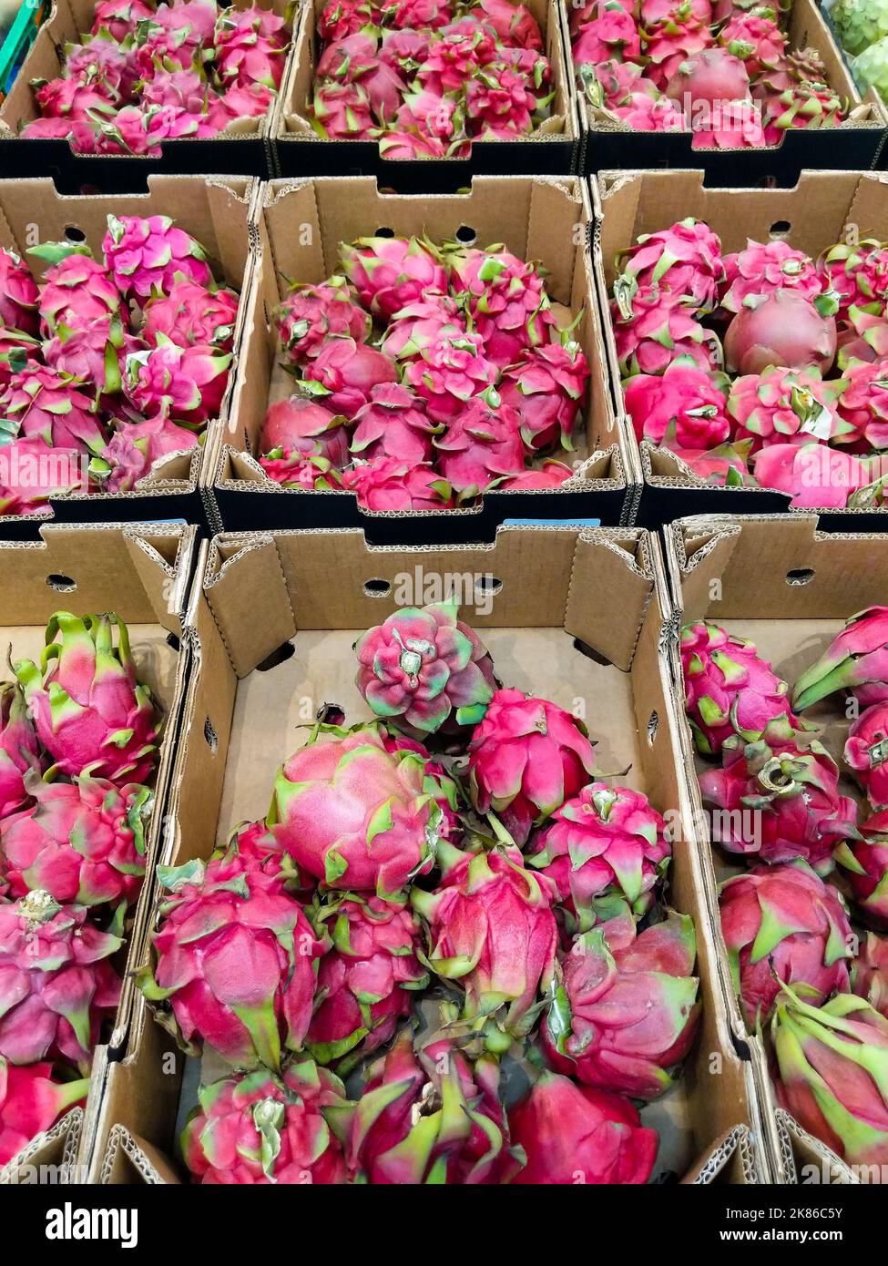 Boxes full of pitaya or dragon fruit in a market Stock Photo - Alamy