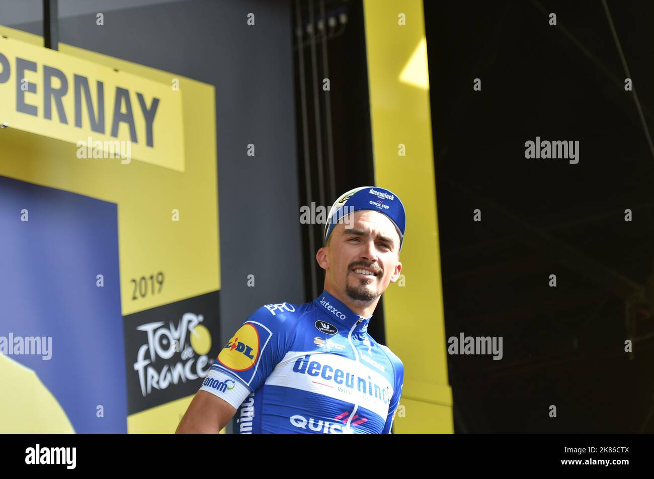 Julian Alaphilippe wins the stage and stands on the podium to celebrate ...