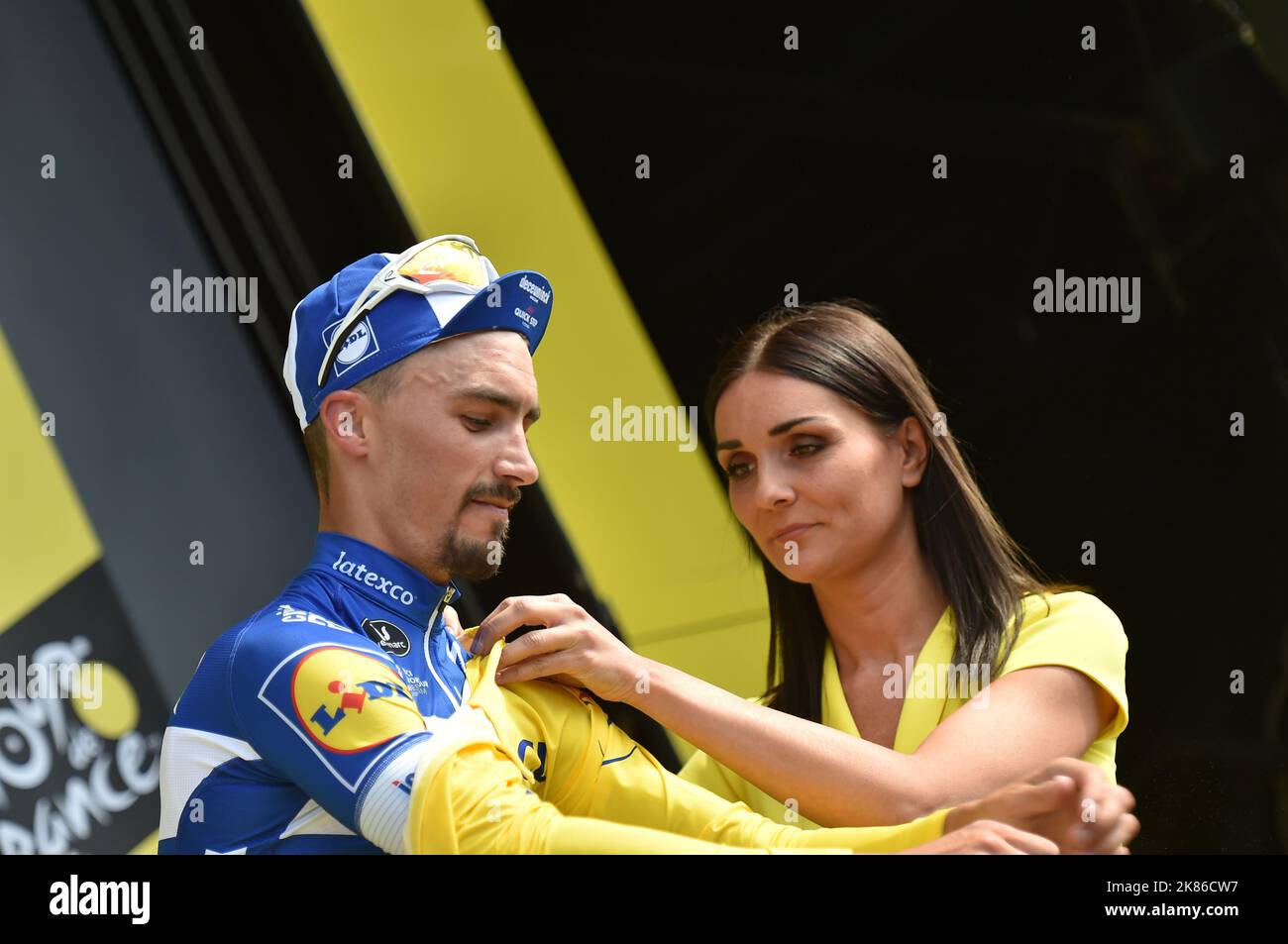 Julian Alaphilippe wins the stage and stands on the podium to celebrate ...