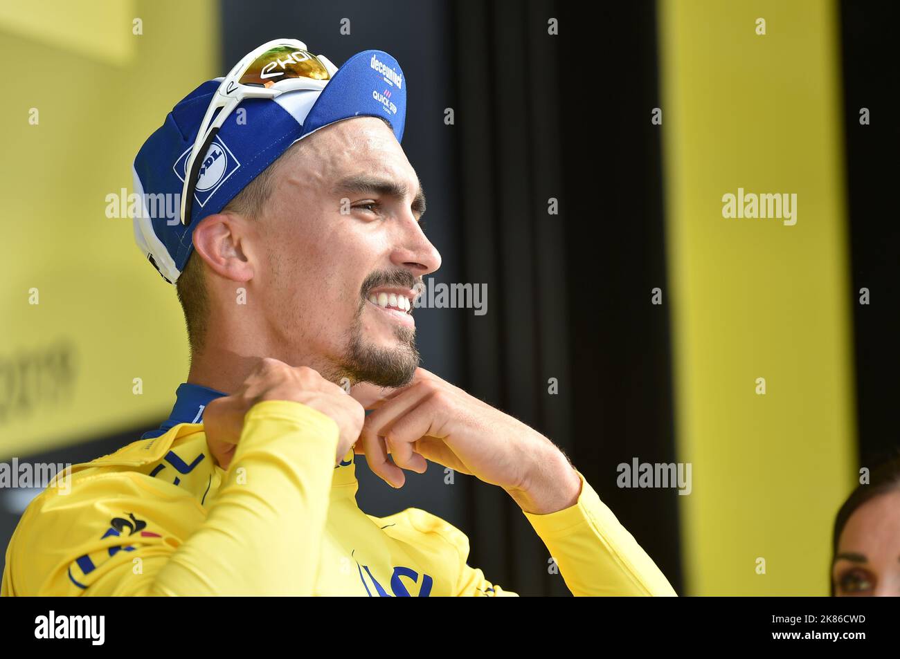 Julian Alaphilippe wins the stage and stands on the podium to celebrate ...