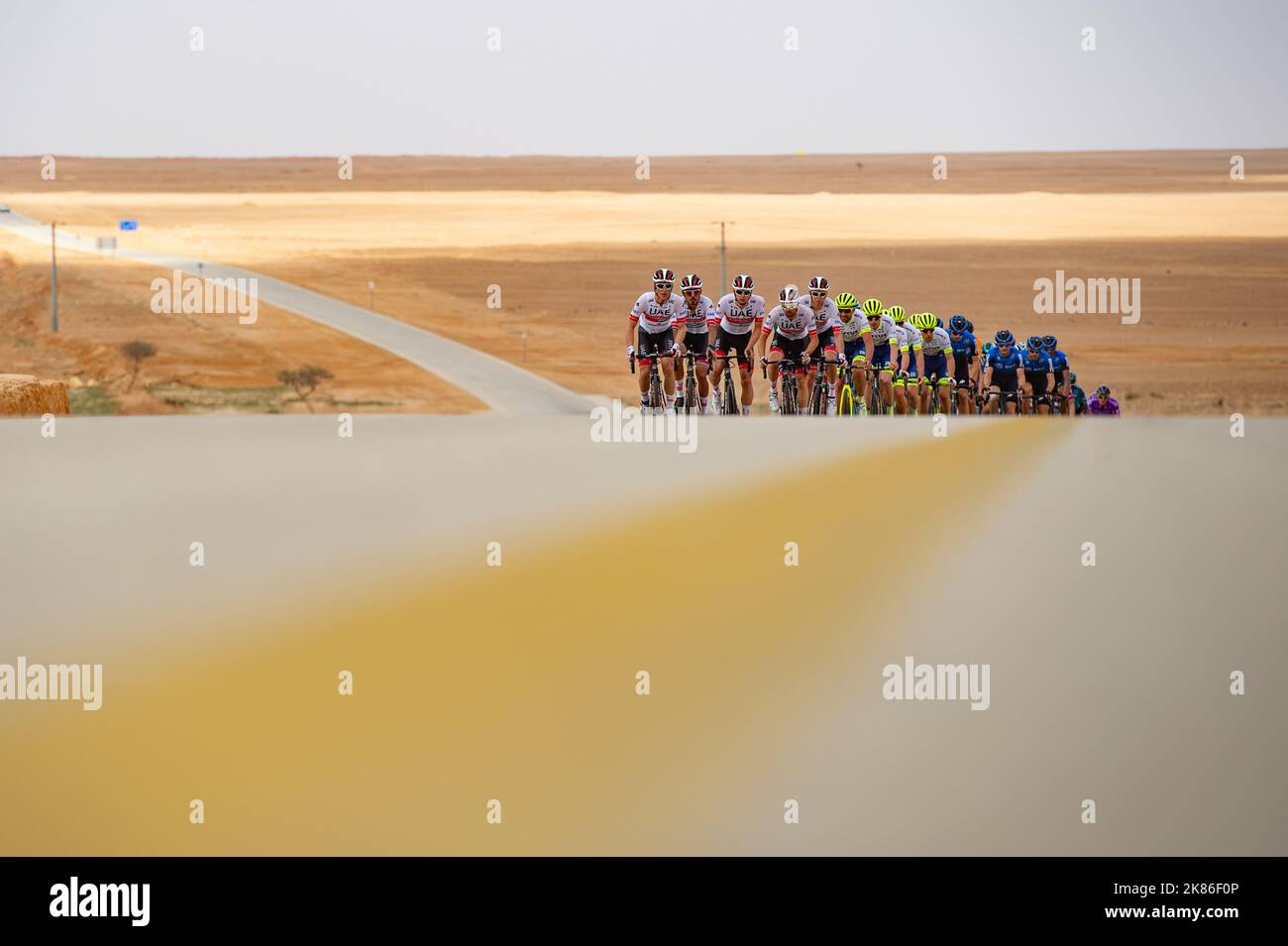 The chasing Peloton lead by the UAE Team Emirates riding though the ...