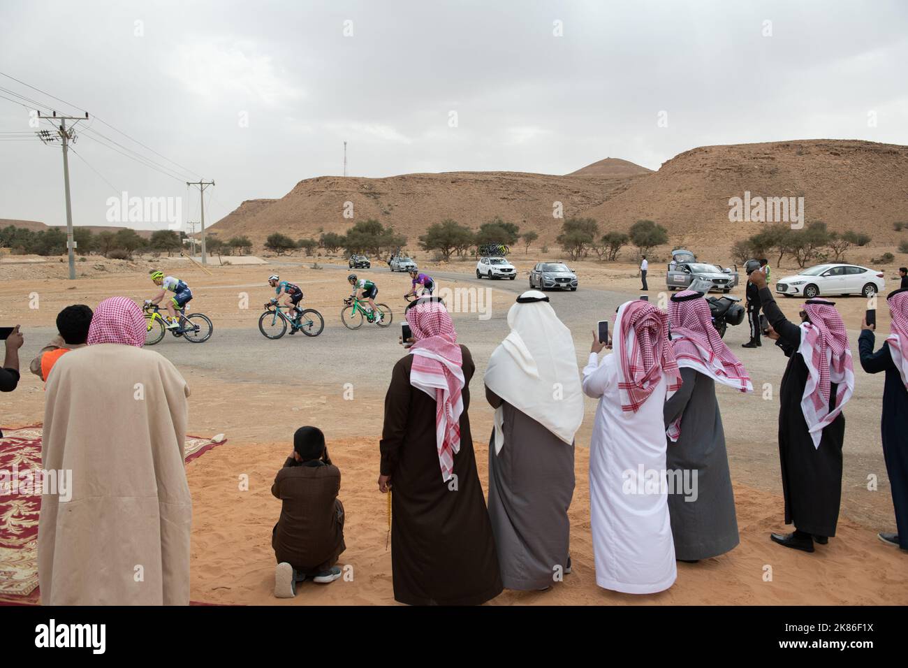 Some Saudi people take photos of riders competing in Stage Two of the ...
