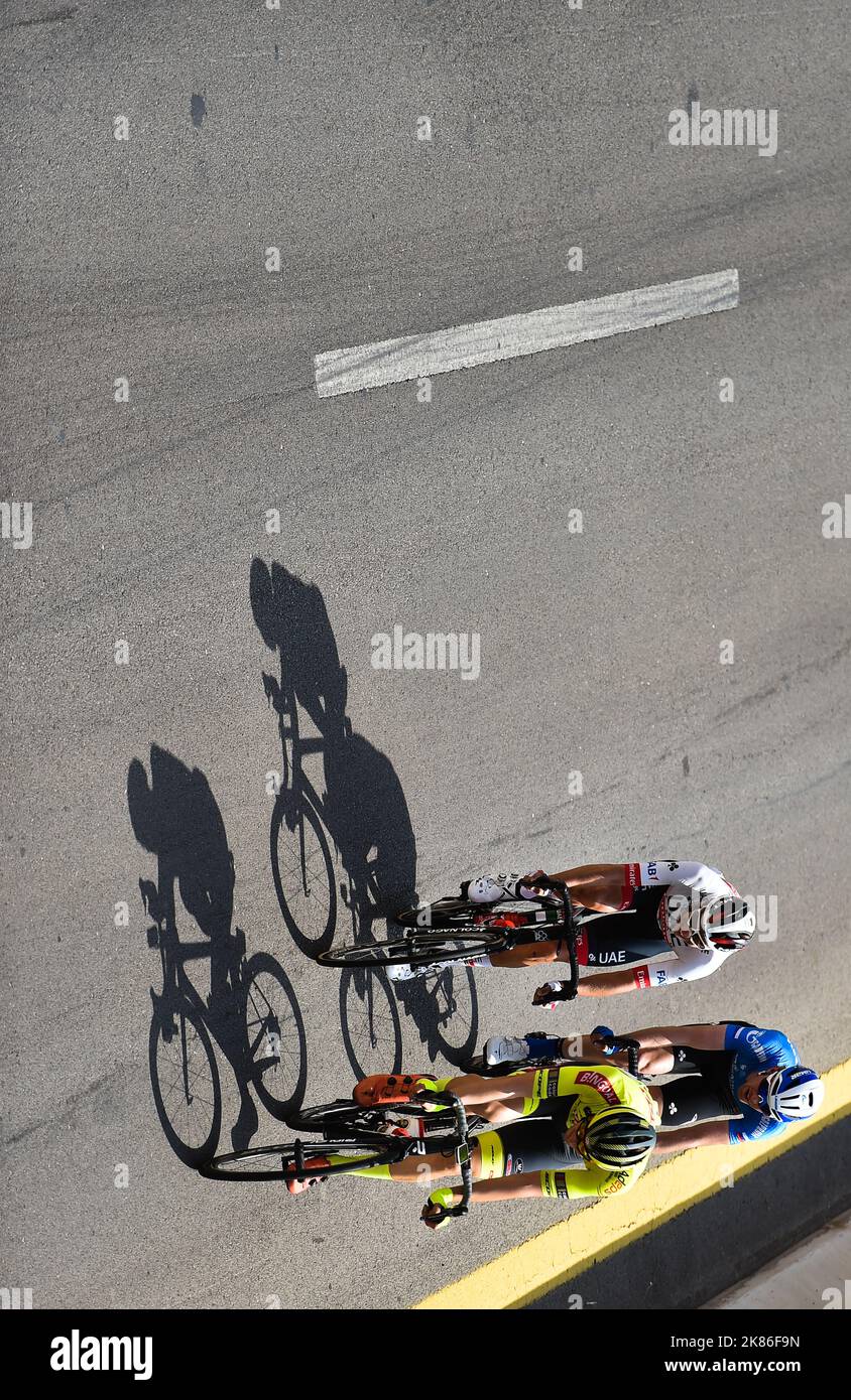 A small group of attacking riders cast their shadow on the highway ...
