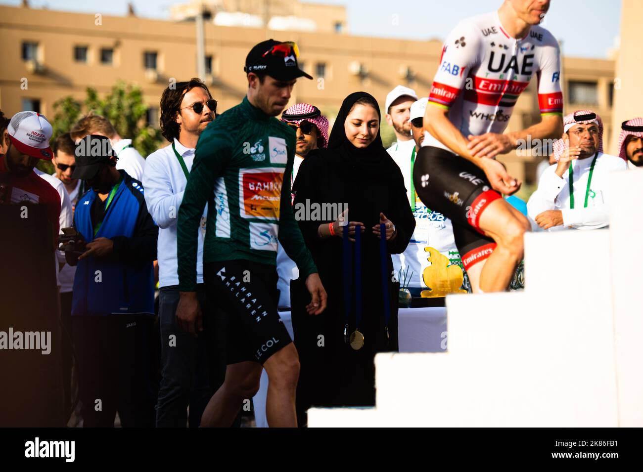 The winners climb onto the podium as a woman prepares to hand over the ...