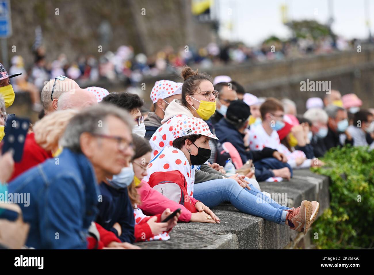 Fans stand wearing masks and watching the opening team presentations of ...