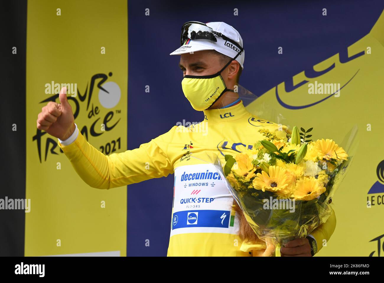 Julian Alaphilippe for team Deceuninck Quick Step stands on the podium ...