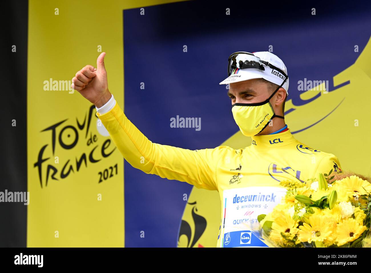Julian Alaphilippe for team Deceuninck Quick Step stands on the podium ...