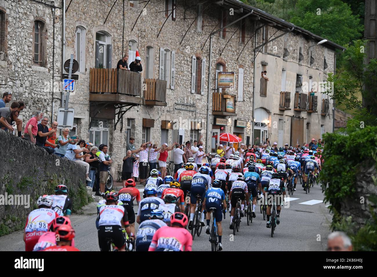 General view of the peloton riding through a small French town in stage ...