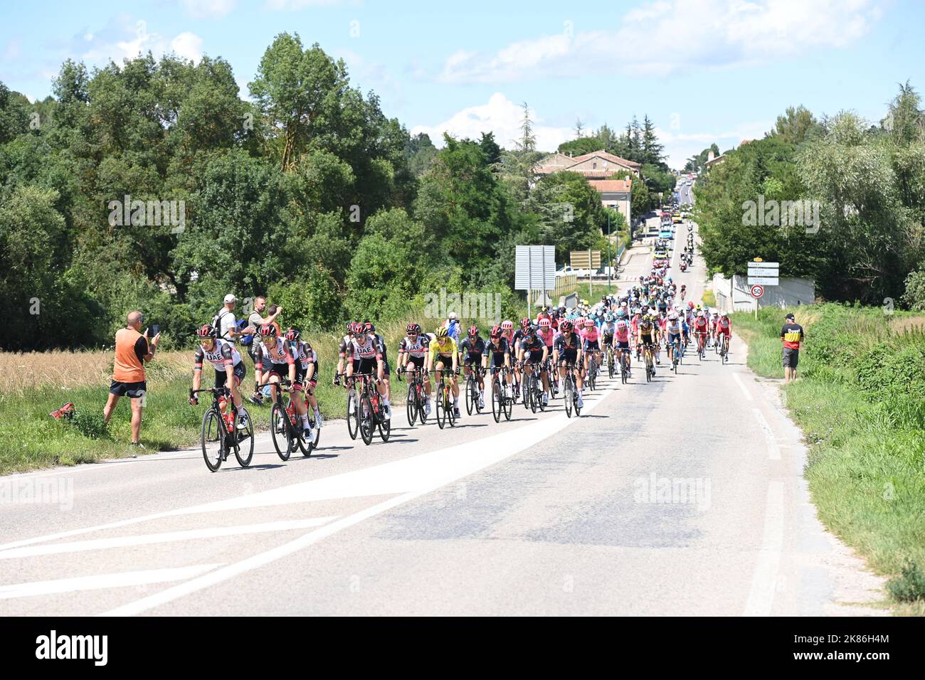 The peloton ride through the French countryside during stage 12 of the ...