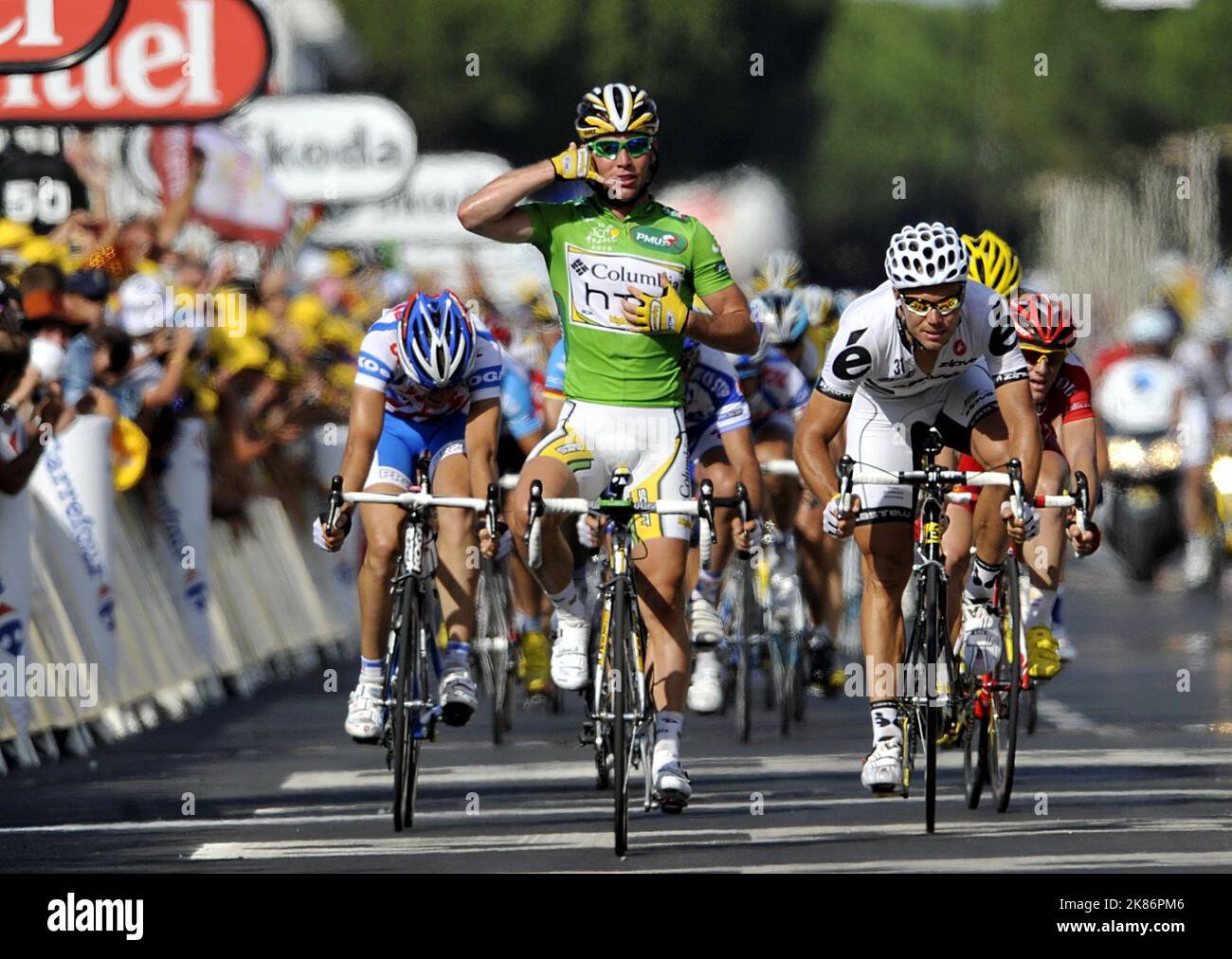 Team Columbia's Mark Cavendish (centre) crosses the line to win the ...