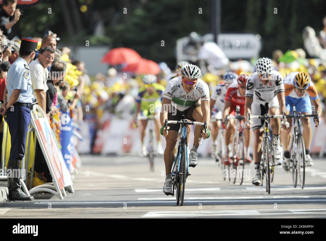 Nicolas Roche crosses the finish line in second place followed by ...