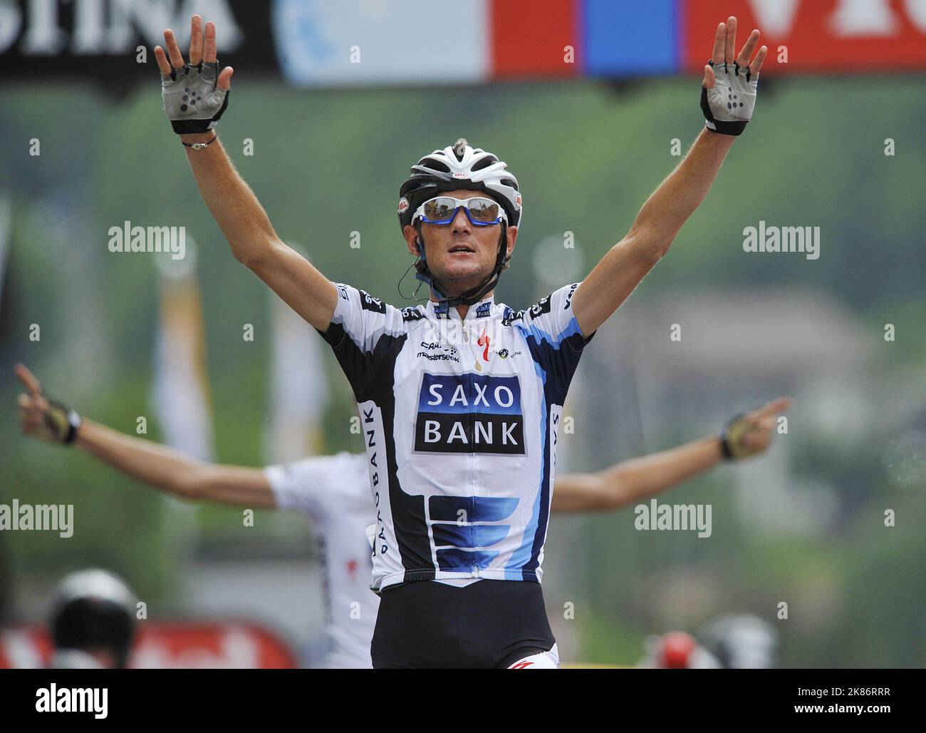 Frank Schleck crosses the finish line to win the stage ahead of his ...
