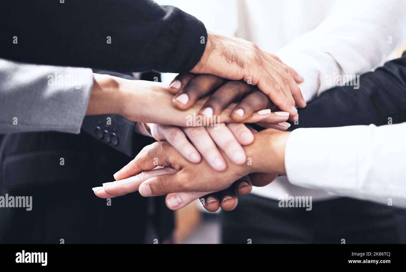 On three we break on dream team. a group of coworkers with their hands ...
