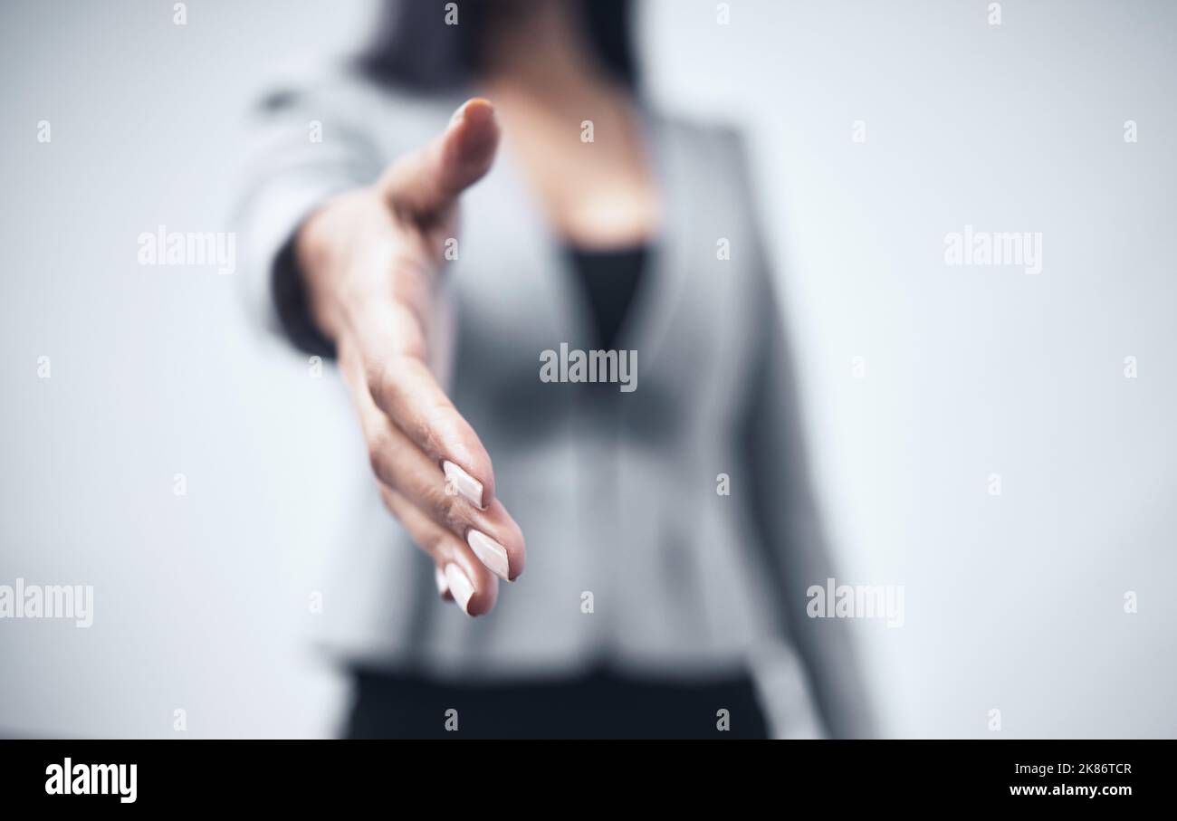 Congratulations on your promotion. a businesswoman holding out her hand ...