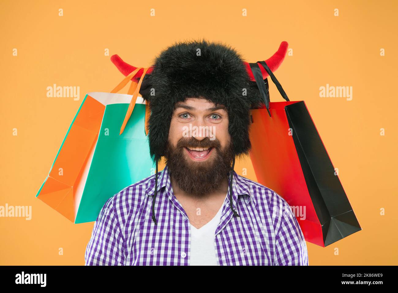 Wild about shopping. Full packages of items. Man strict face wear hat ...