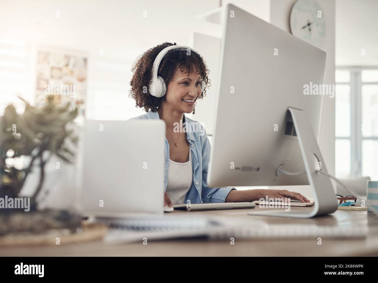 Music boosts creativity. an attractive young woman sitting alone at ...