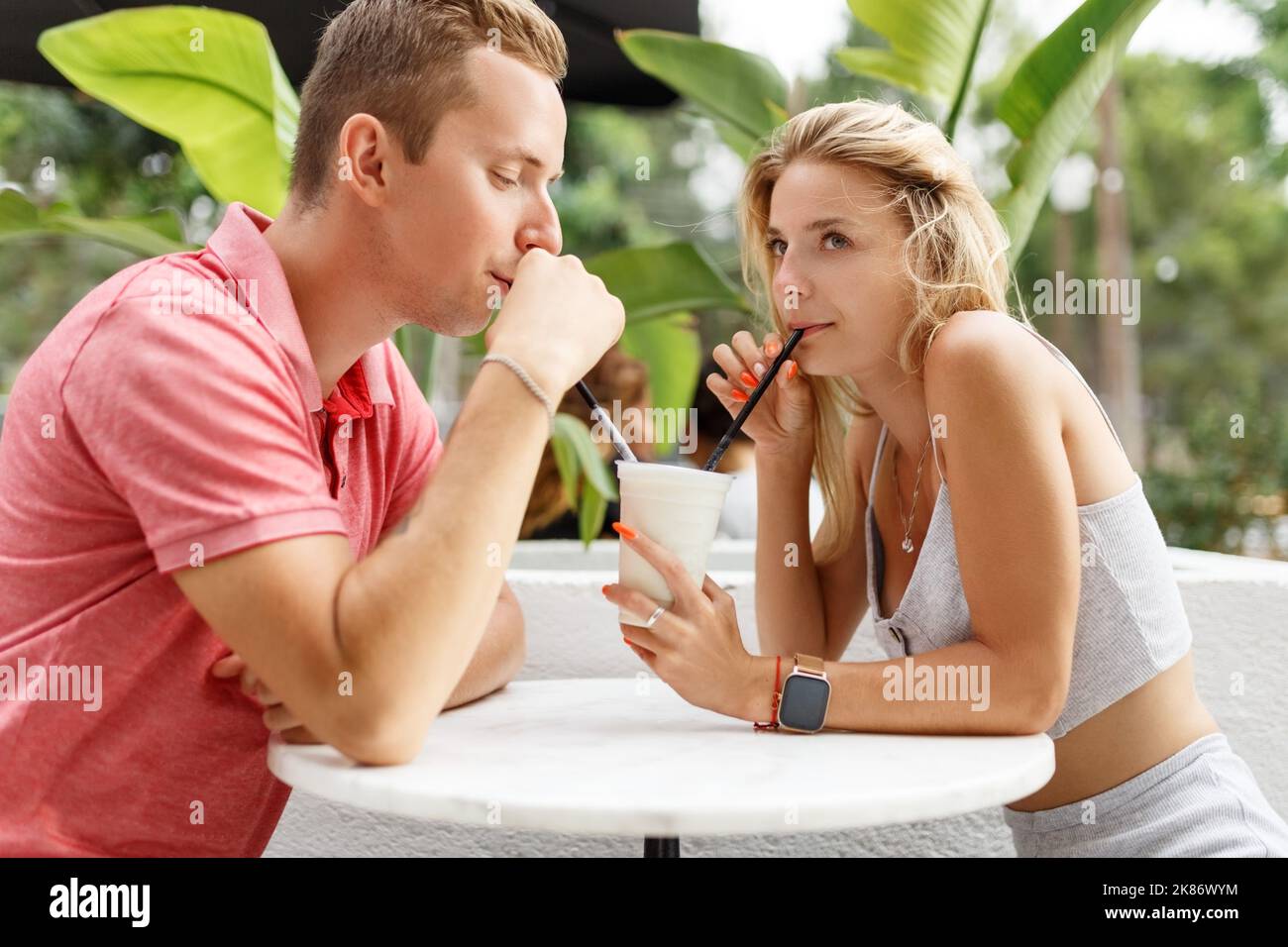 Young couple sitting in a cafe and speaking. Students during break in ...