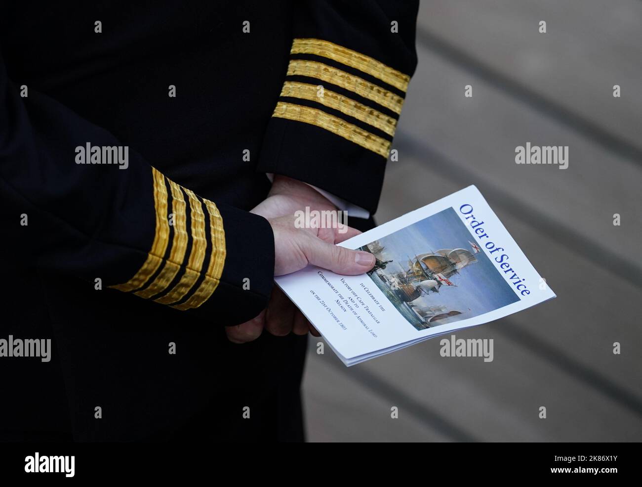 A Royal Navy Captain holds an order of service on board HMS Victory in ...