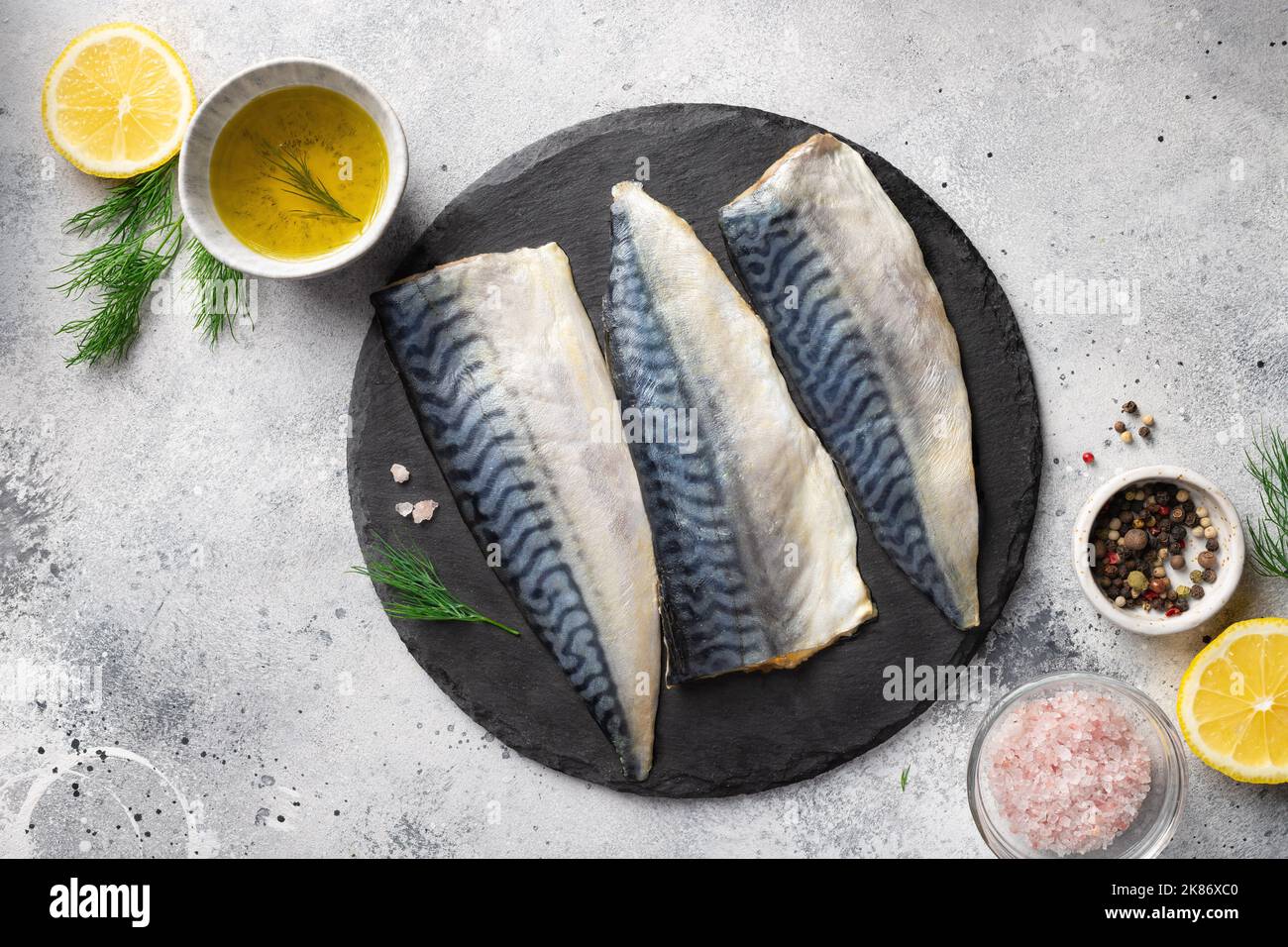Raw fresh fillet mackerel fish with aromatic herbs, spices, lemon and ...
