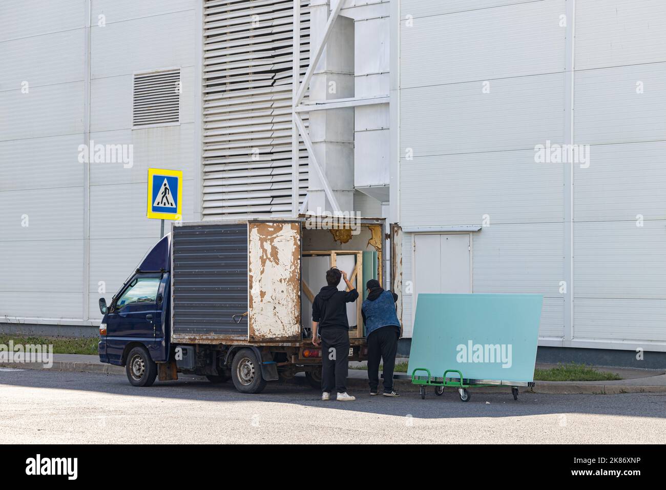 Moscow, Russia - October 14, 2022: worker loading construction material ...