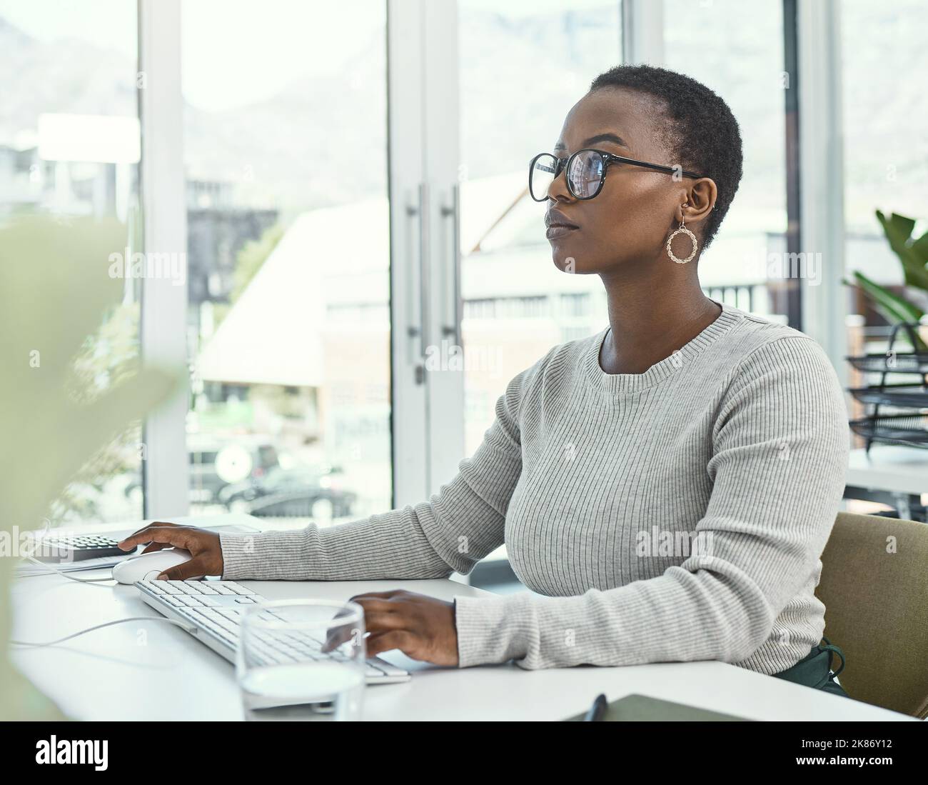 Nothing will break my focus. a young businesswoman using her computer ...