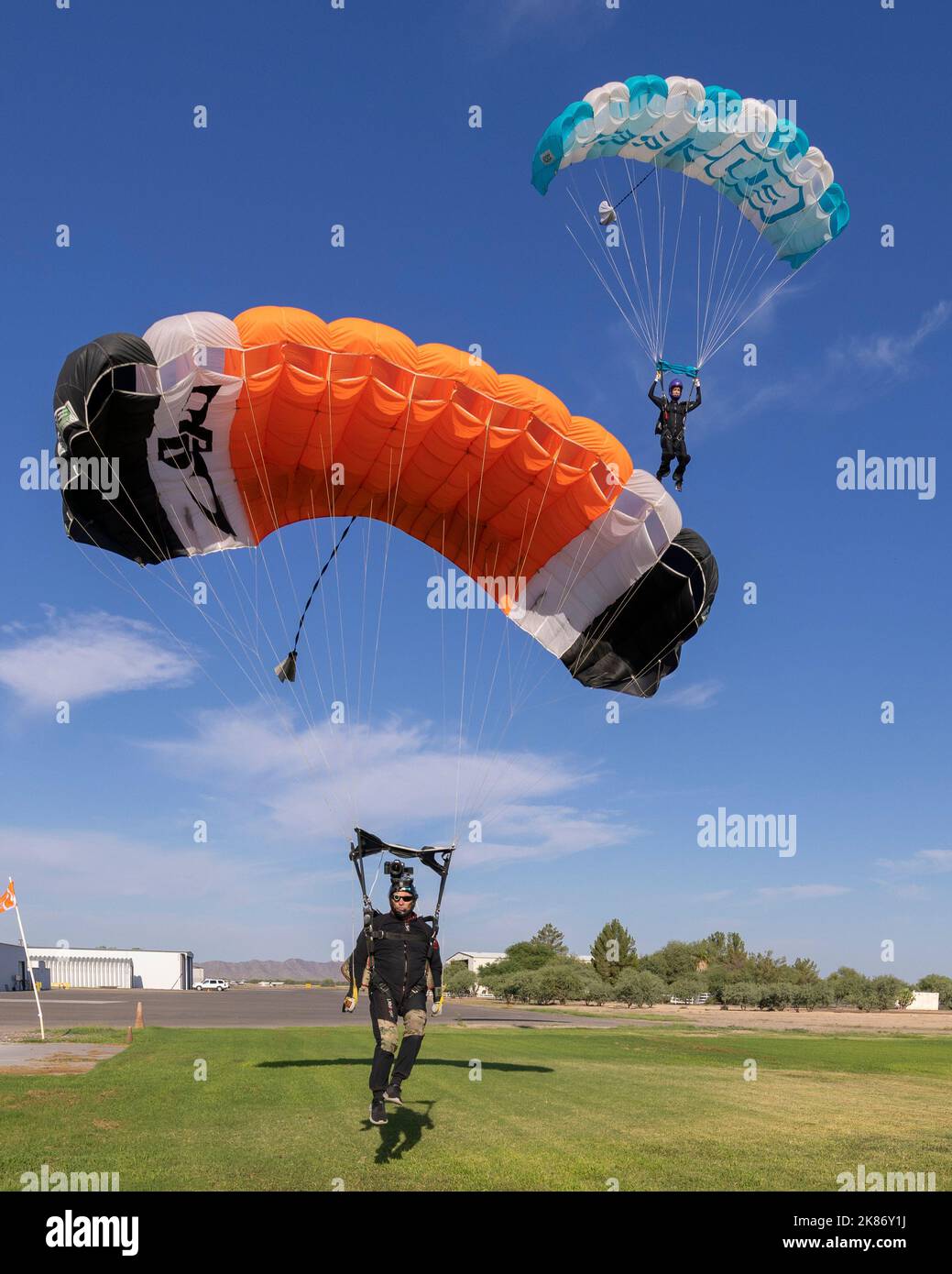 Two skydivers land next to each other on the DZ Stock Photo - Alamy