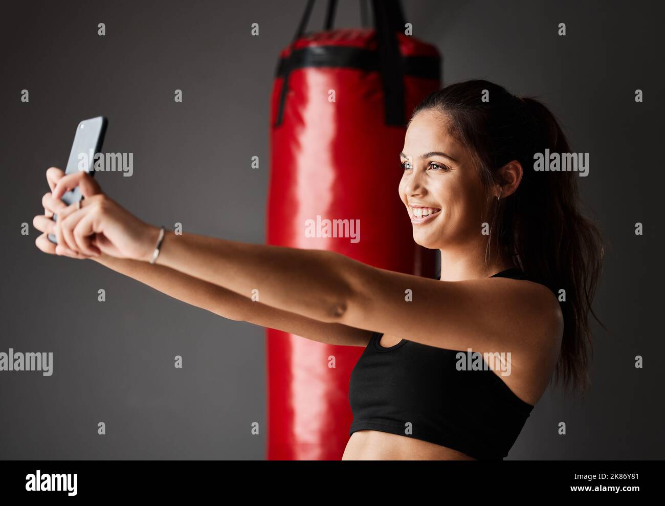 Before and after selfies are where its at. an attractive young female boxer taking selfies while ...