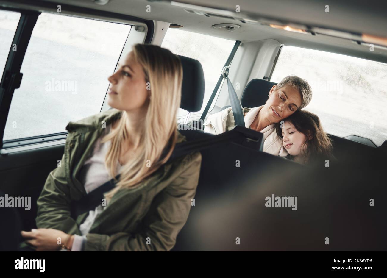 Road trip, driving and family sleeping in the car tired from adventure ...