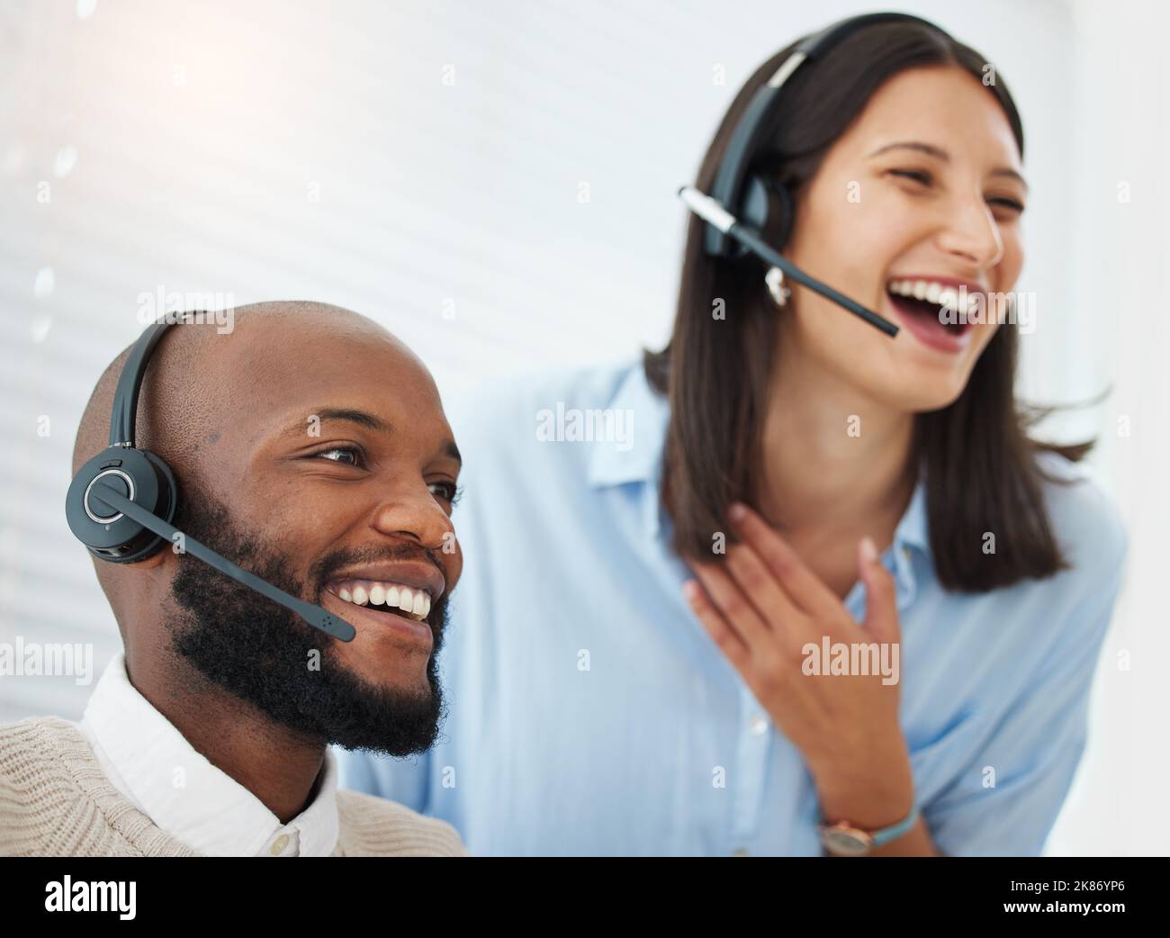 Funny coworkers are the best. a handsome young salesman sitting in the ...