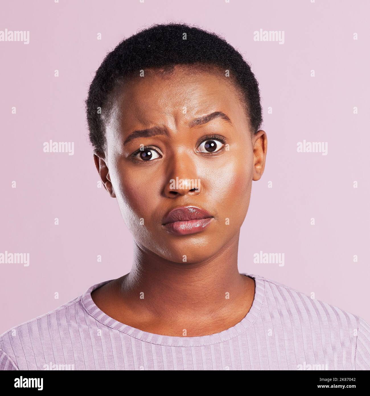 I dont understand. Studio shot of a young woman looking confused ...