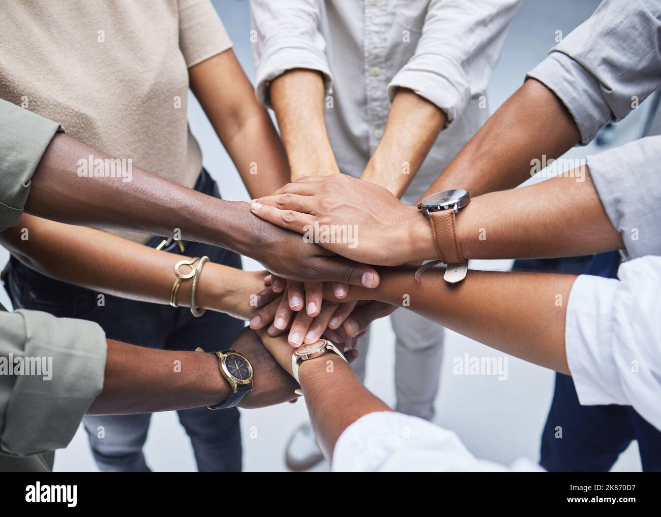 Teamwork is at the fore of success. High angle shot of a group of unrecognisable businesspeople ...