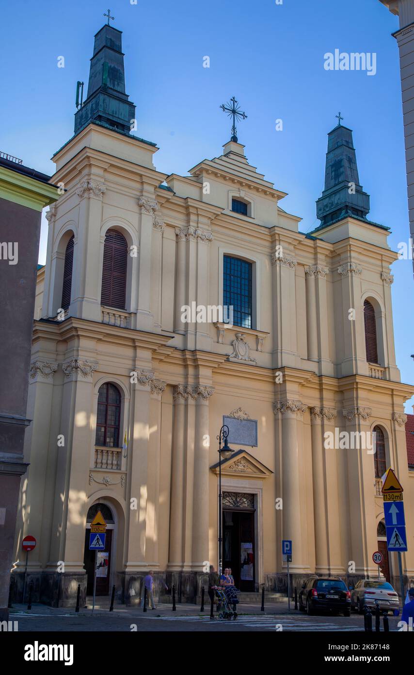 The yellow facade of the twin tower Catholic Church (Warsaw, Poland ...